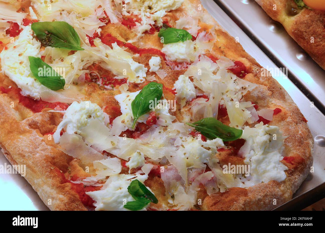 Italian focaccia called ROMAN PINSA with basil cheese and tomato sauce ...