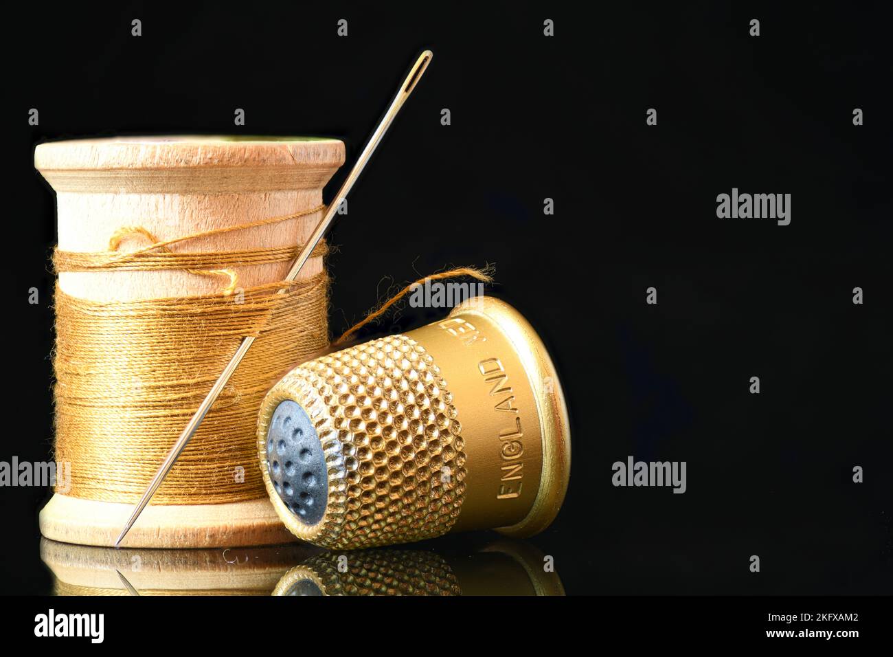 Needle and Thread on dark background Stock Photo - Alamy