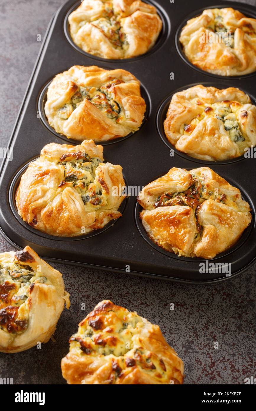 Spinach and feta muffins in puff pastry closeup in the maffin baking ...