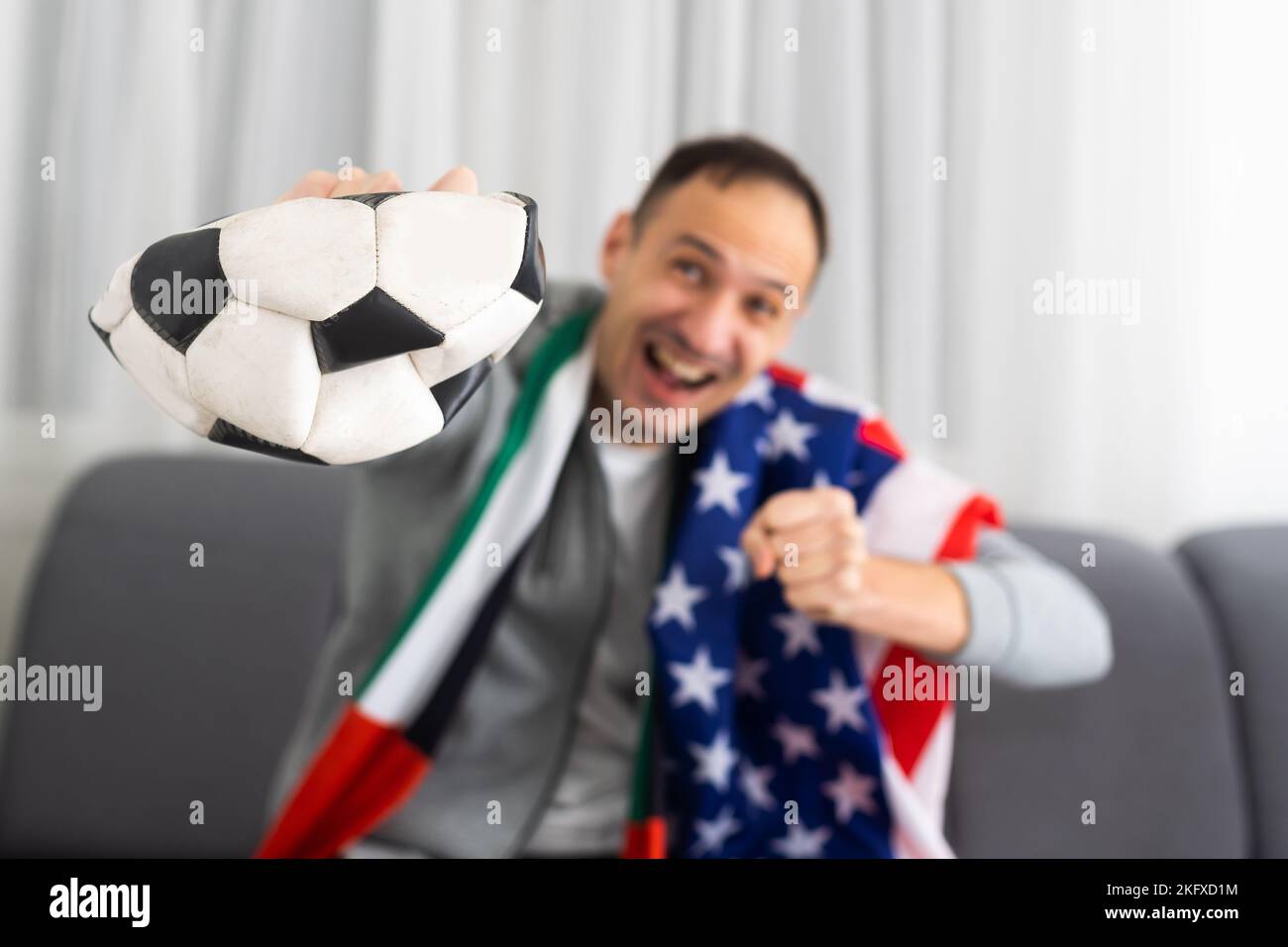 Young sad unhappy man fan in brown shirt hold remote controller spread ...