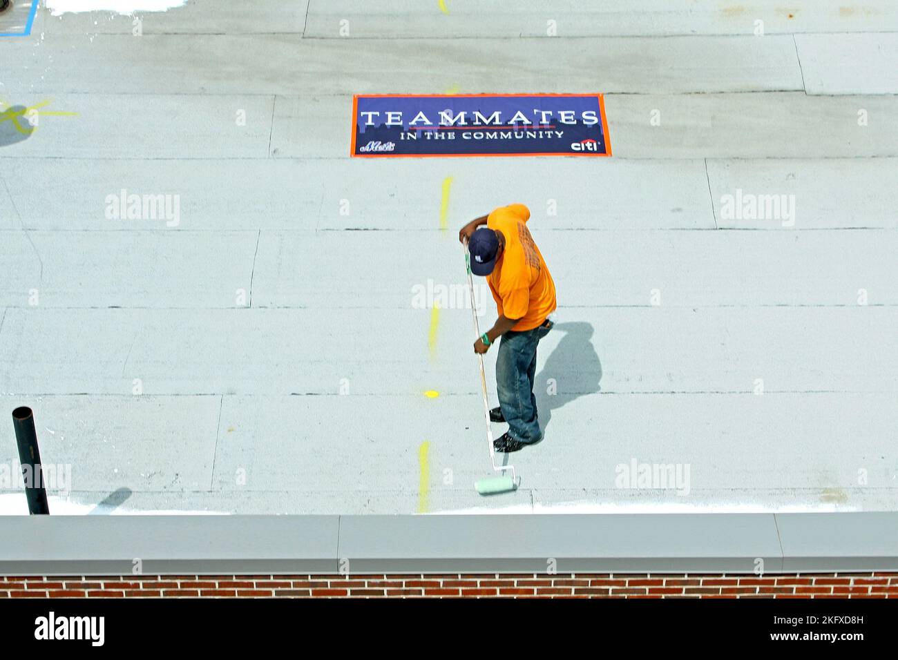 Brooklyn, NY, USA. 23 June, 2010. Volunteer applying coat of reflective ...