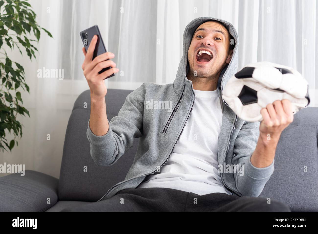 Football fan using mobile phone hi-res stock photography and images - Alamy