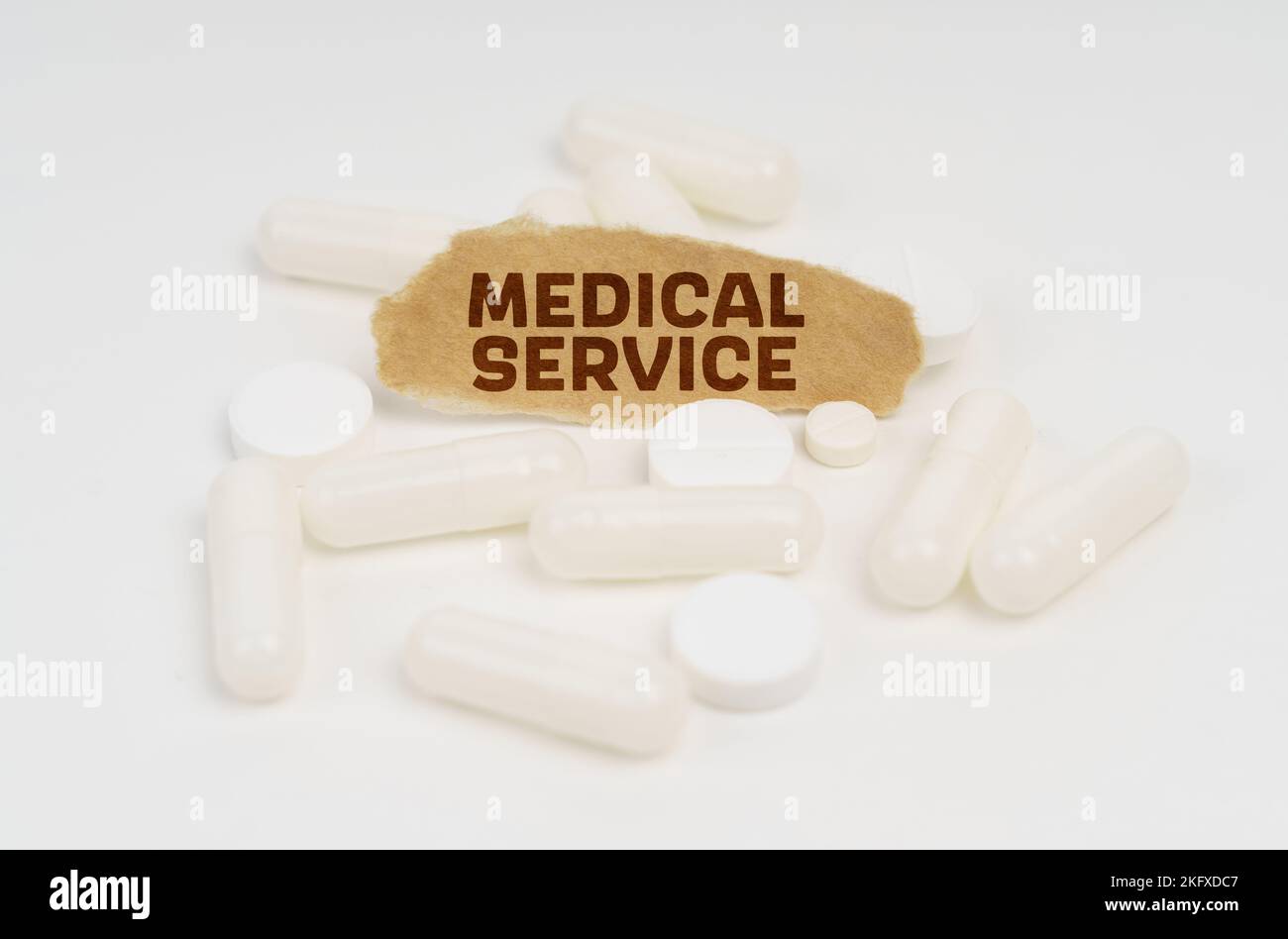 Medicine and health concept. On a white background pills and a piece of ...