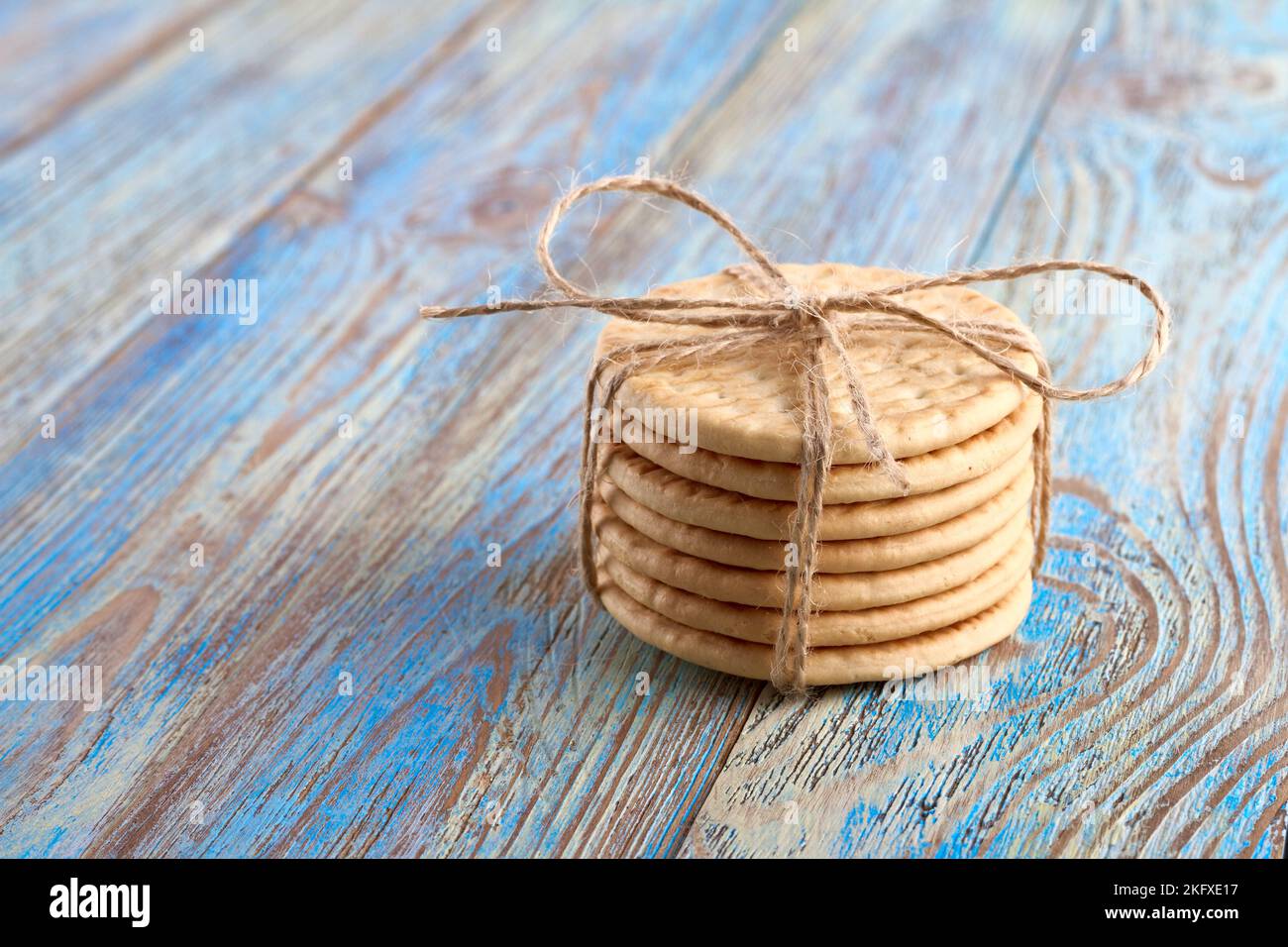 Pile of corded cookies on blue wooden background Stock Photo - Alamy