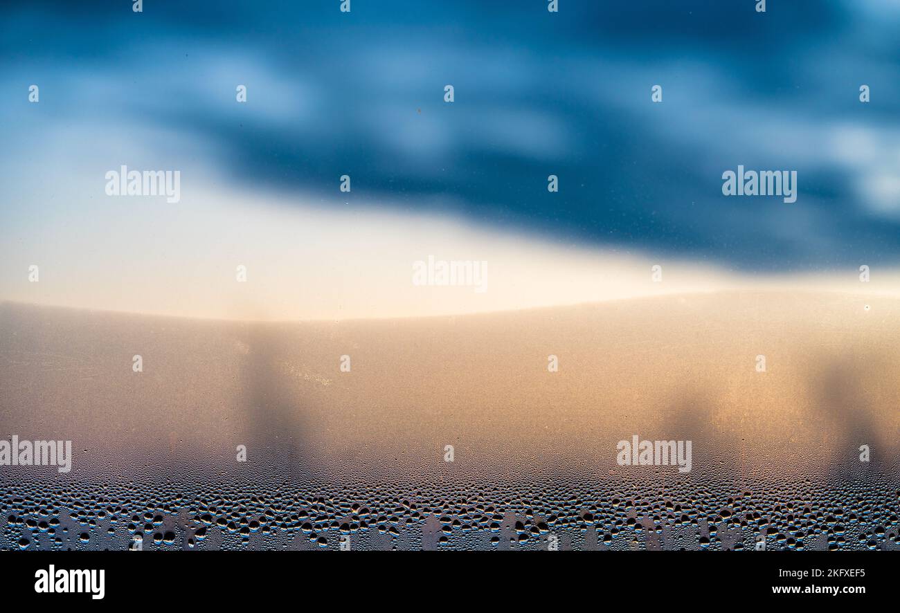 condensation from a drop of water on a window pane during an autumn ...