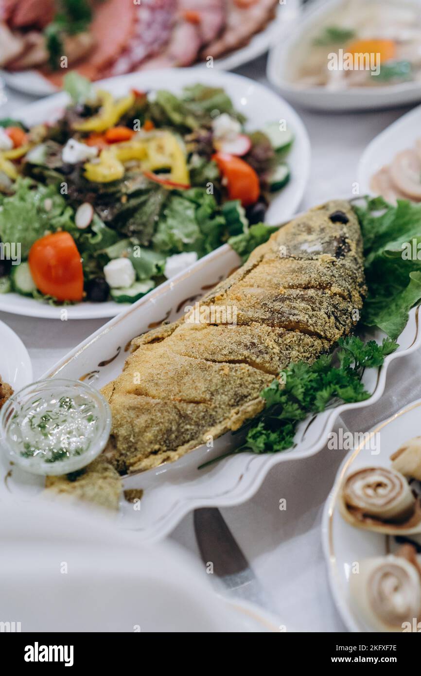 deep-fried sea bass dishes topped with herbs and spicy sauce Stock ...