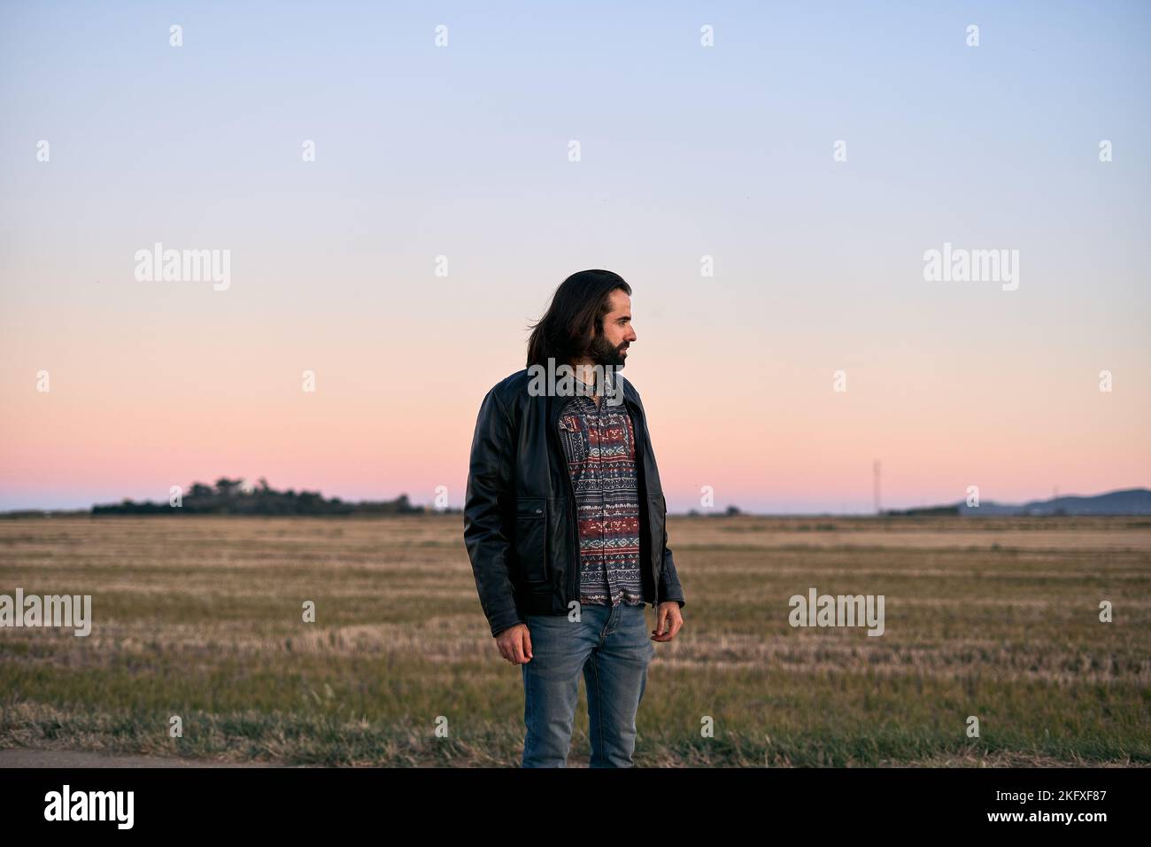 caucasian guy with long hair and beard in profile in the middle of a ...