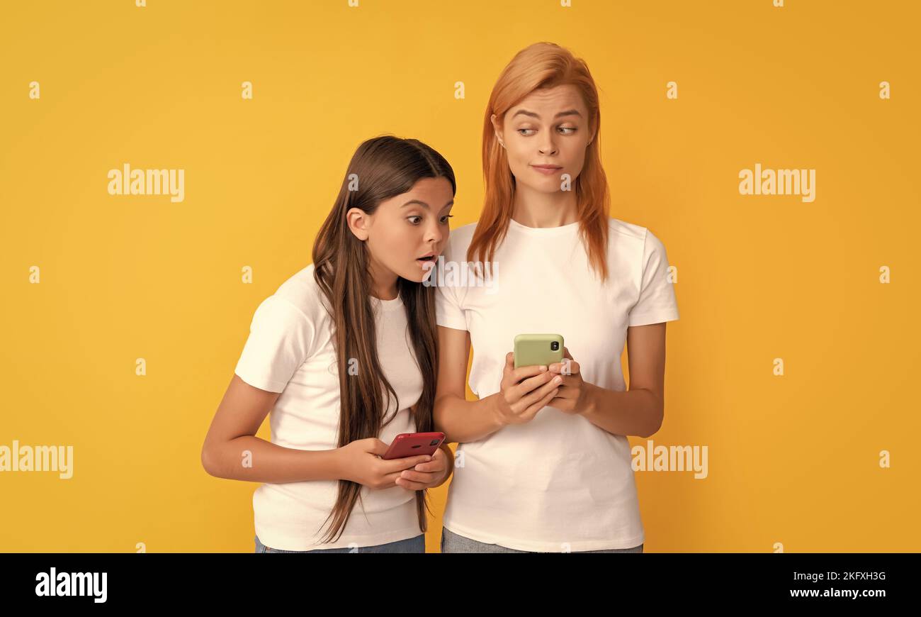 mother and daughter typing and texting. sms and instant messaging. mom ...