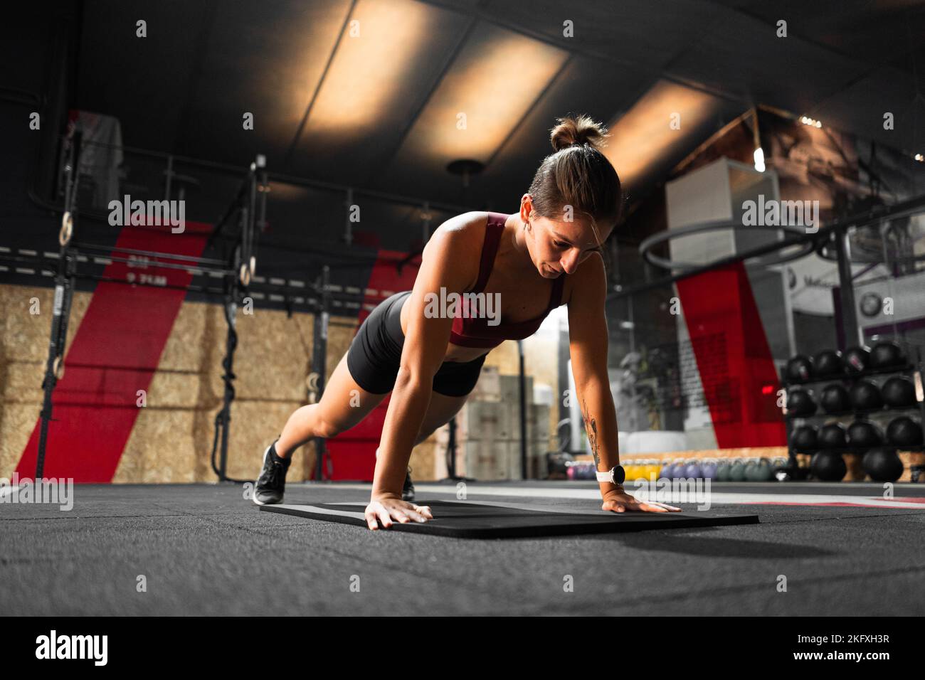 brunette caucasian girl doing crossfit alone lying on the floor of a ...