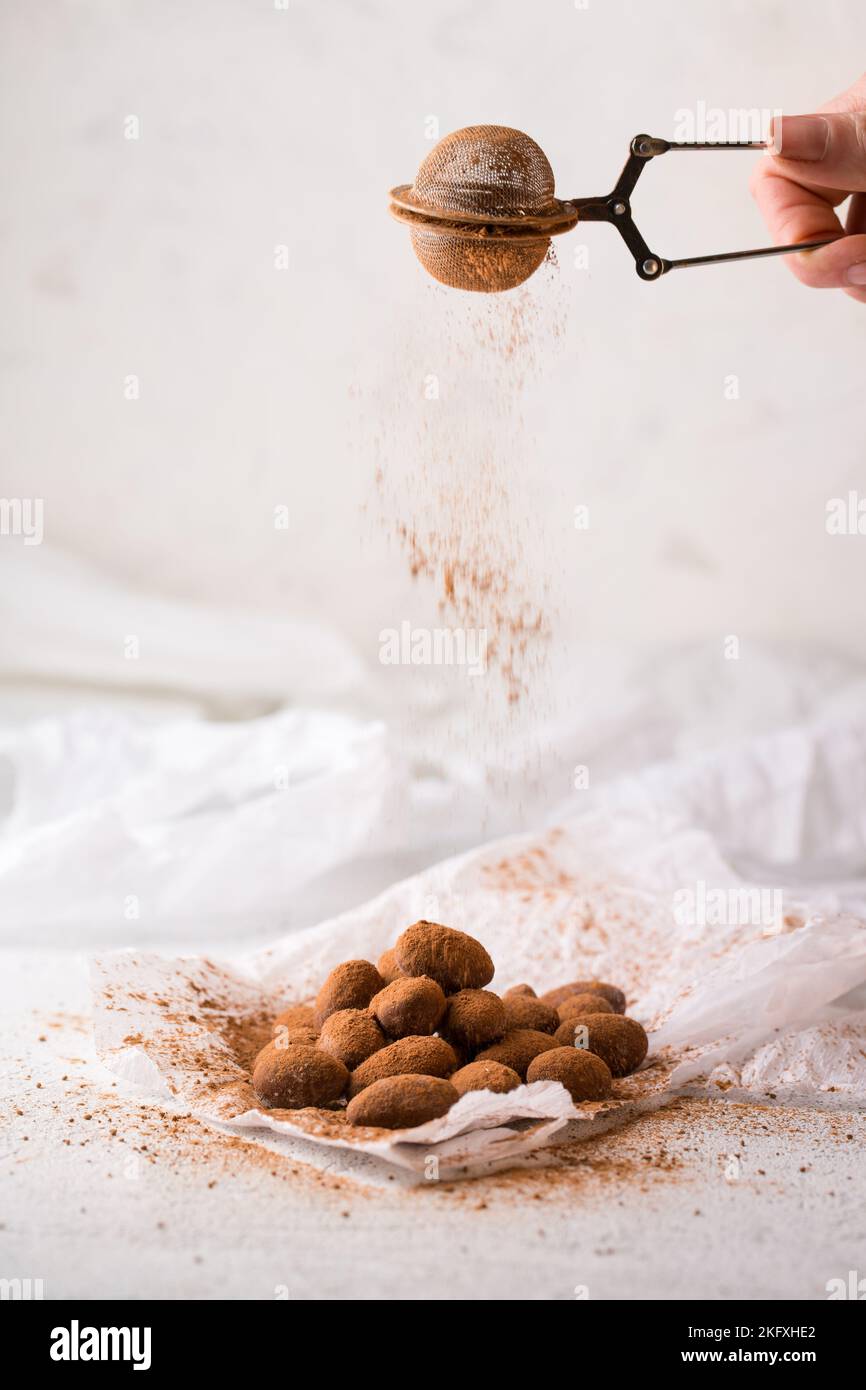 Roasted almonds in chocolate and cocoa powder on a white background ...