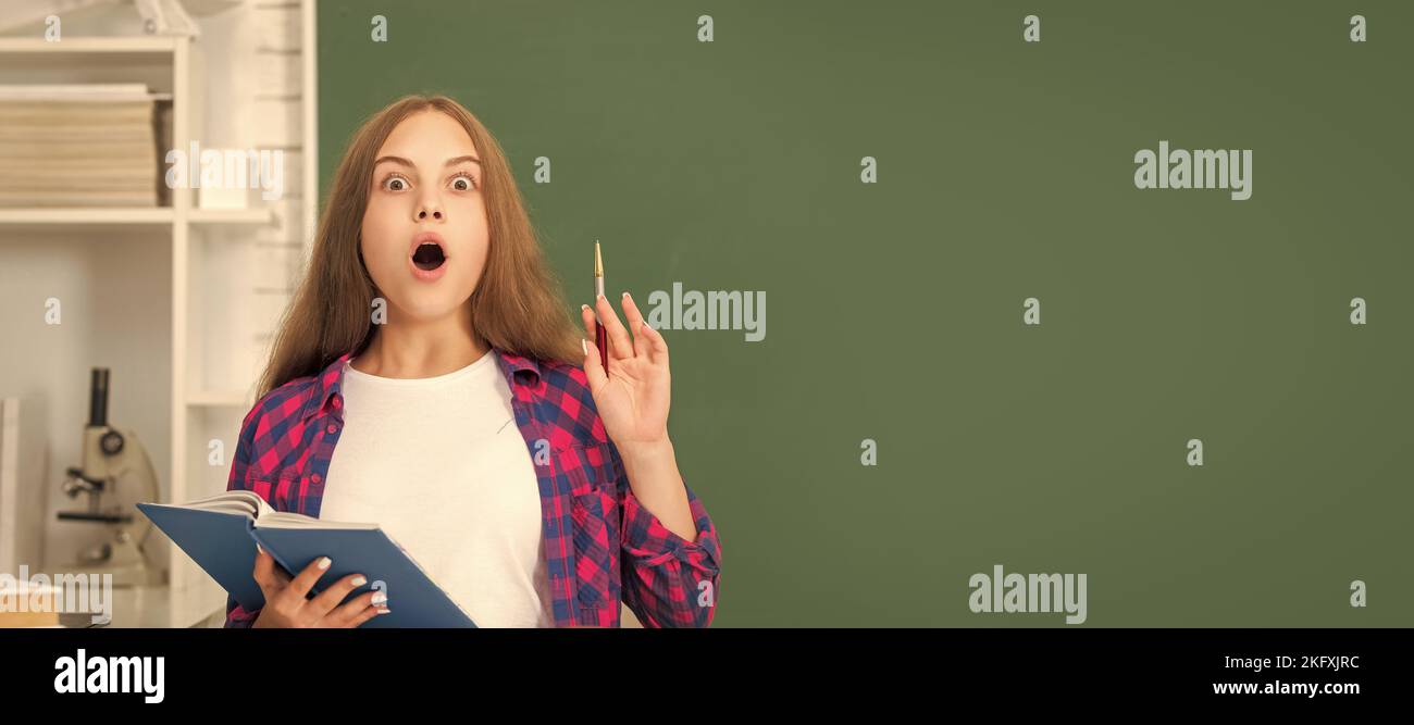 amazed child study at school with book on blackboard background ...