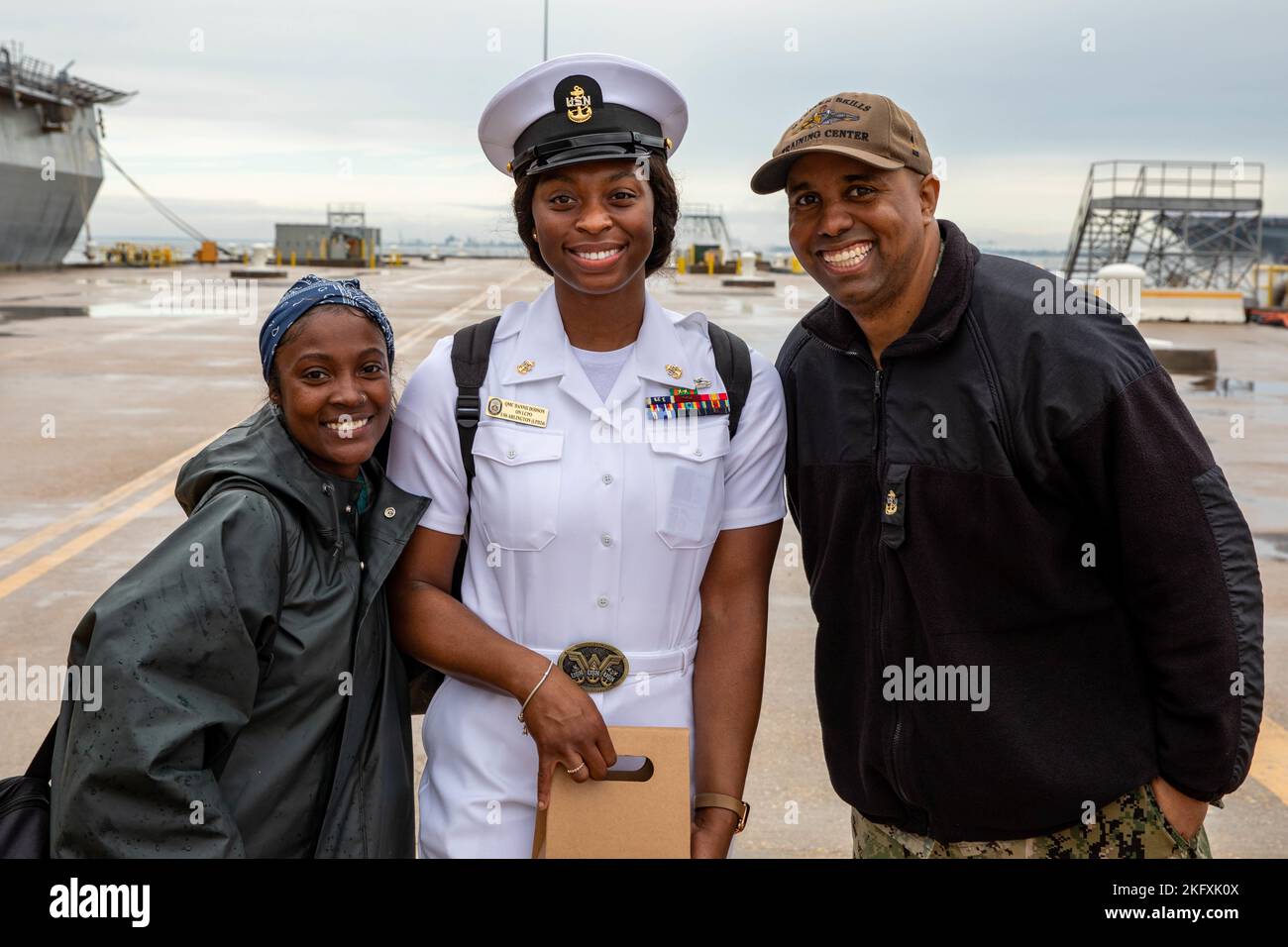 U.S. Navy Chief Quartermaster Keandrea Dodson, center, assigned to the ...