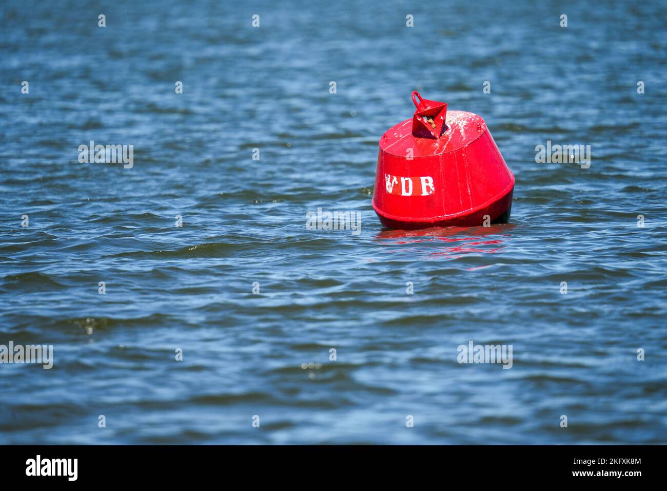 A red buoy floating on water Stock Photo - Alamy
