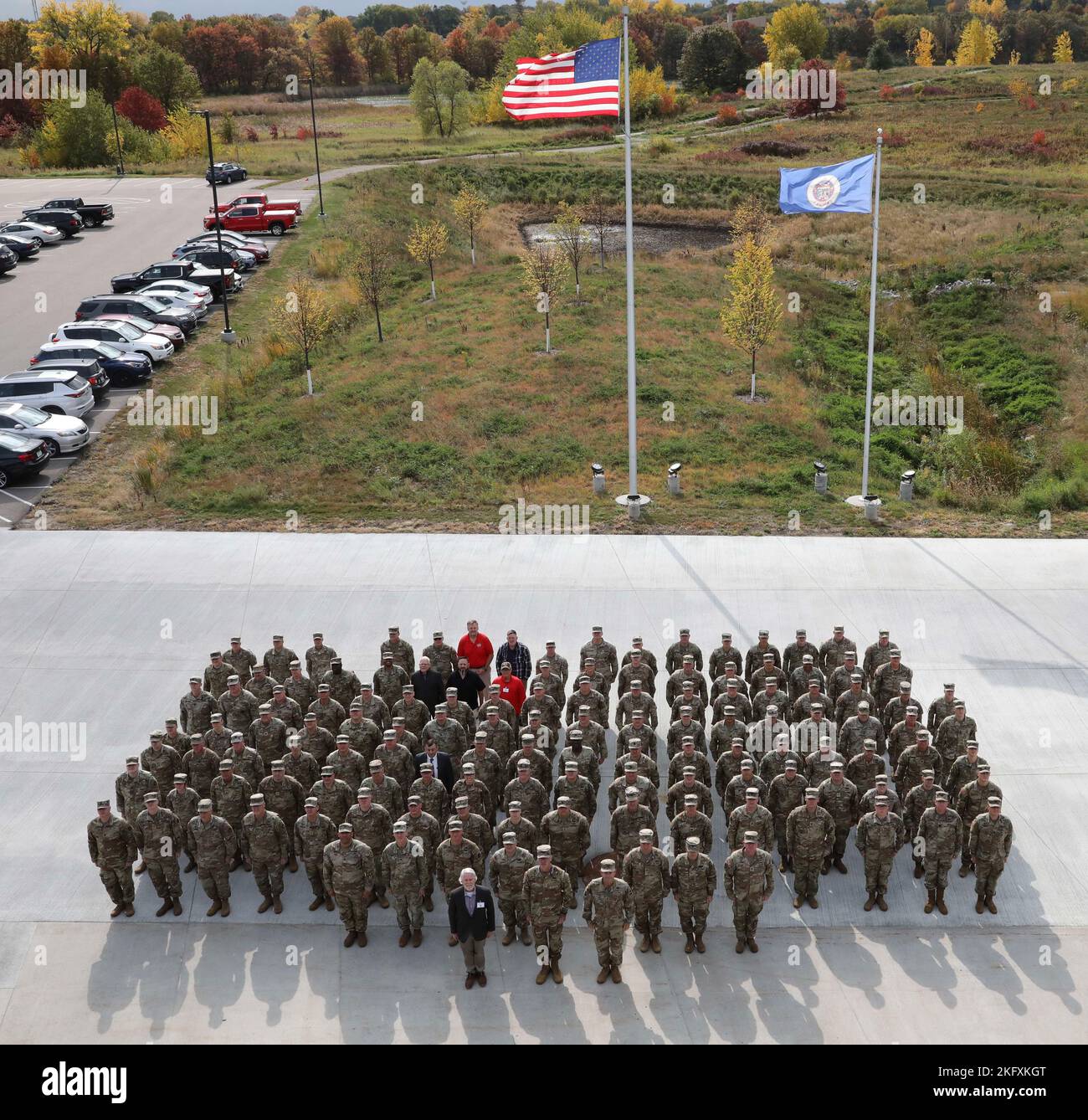 Symposium attendees stand in a formation for a photo. At the General ...