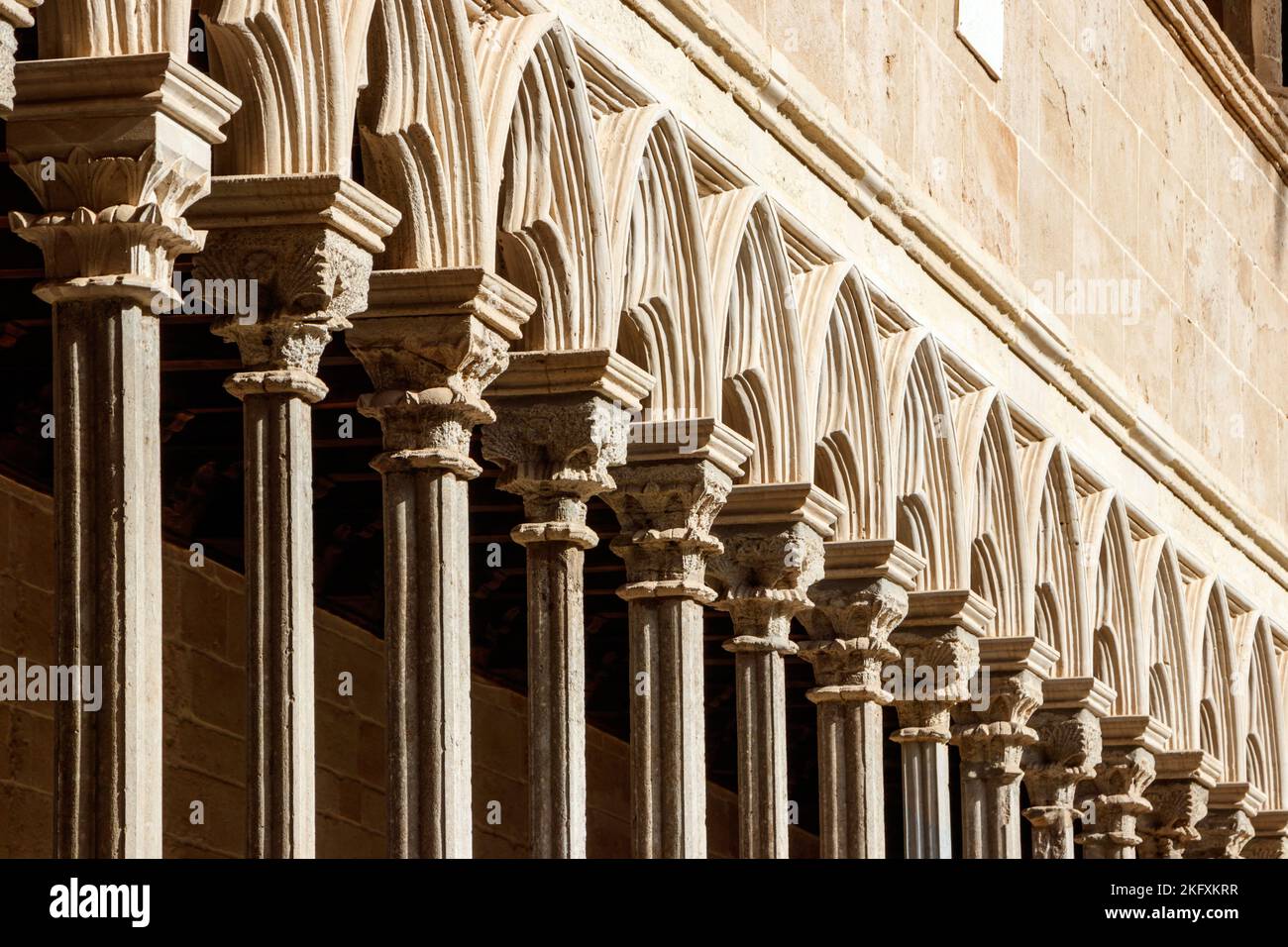 row intricately carved stone columns arches historic building detailed ...