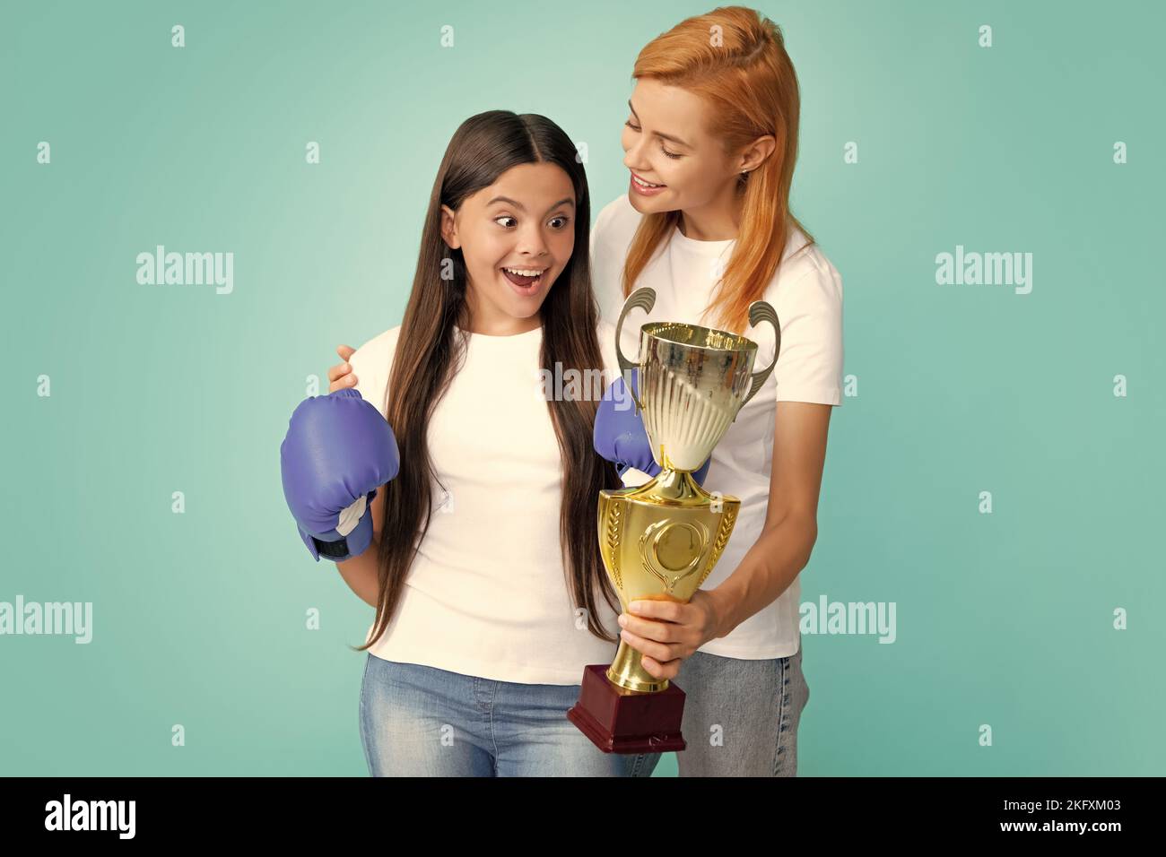 Woman power. Sportive young woman and her daughter wearing boxing ...