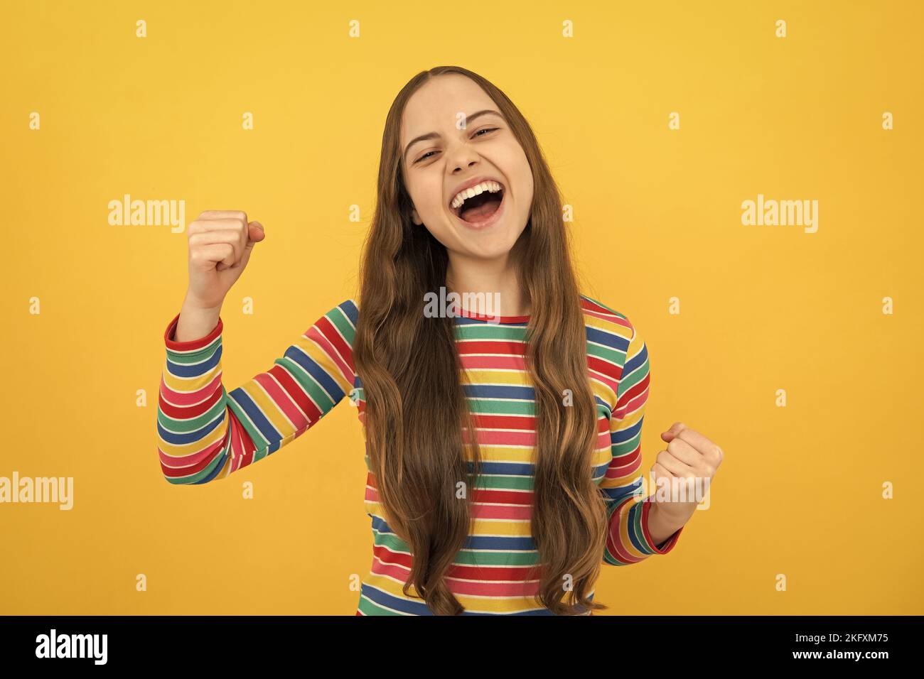 Child girl rejoicing, say yes, looking happy and celebrating victory ...