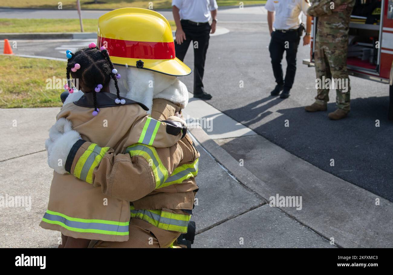 A child from the Child Development Center receives a hug from Sparky ...