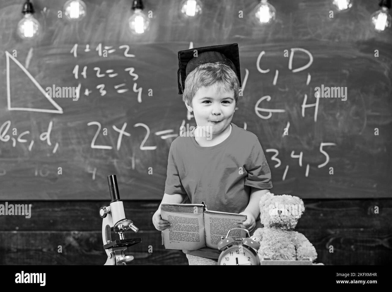 First former interested in studying, education. Kid boy in graduate cap ...