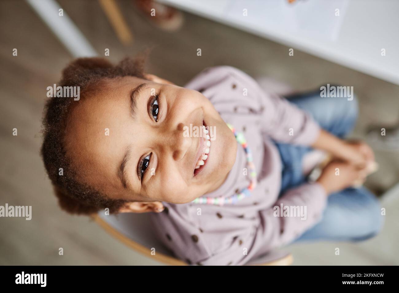 Above shot of face of happy little African American learner of nursery ...