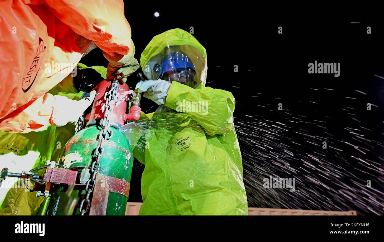 A team of Airmen stop a simulated leak on a 150 pound cylinder tank ...