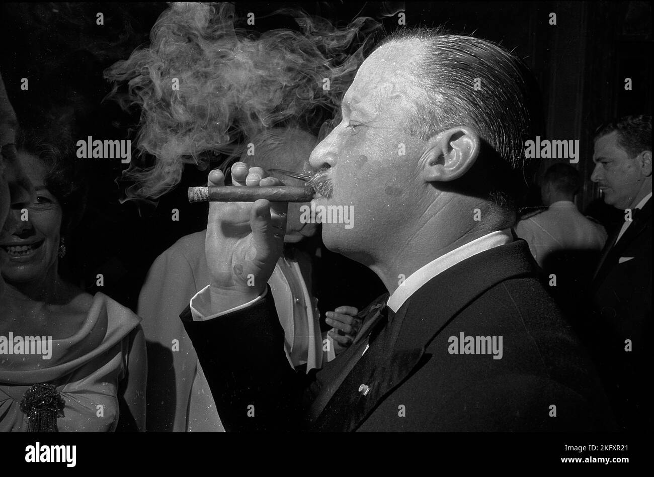Juan Carlos Onganía, Argentine defacto president, smokes a cigar at a ...
