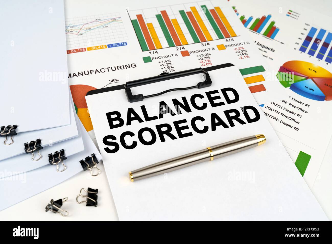 Business concept. On the table among financial graphs and charts lies a ...