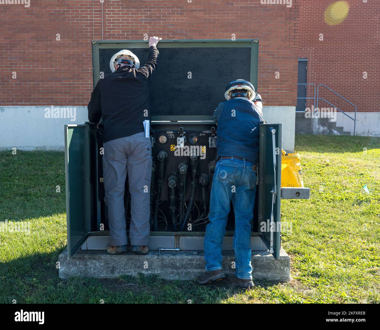 Marty Wright, AES Ohio leader lineman, opens the top of a generator ...