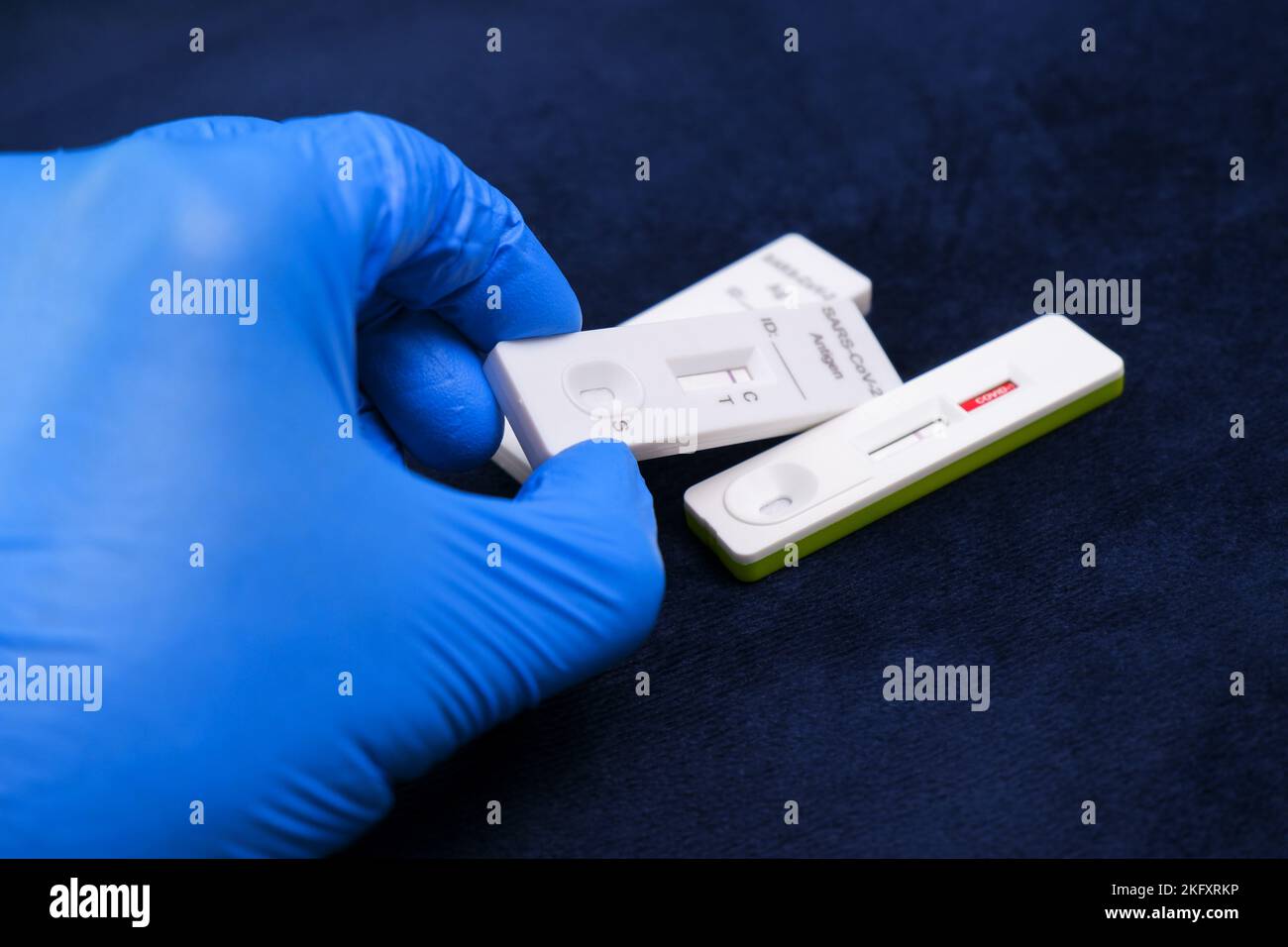 Hand of a healthcare worker picking up a negative covid-19 test result ...
