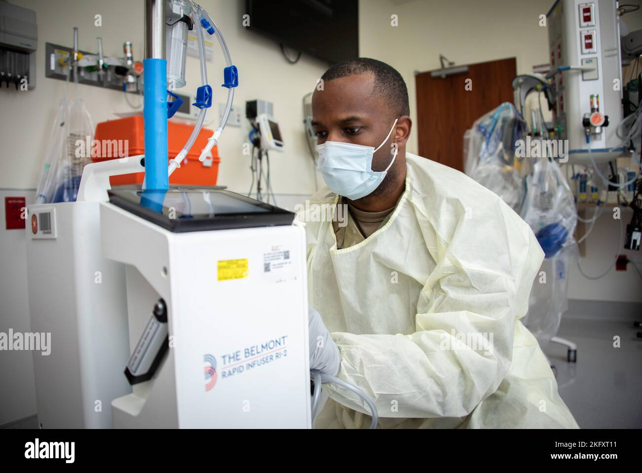 Air Force Capt. Craig Taylor Burton, clinical nurse, primes a rapid ...