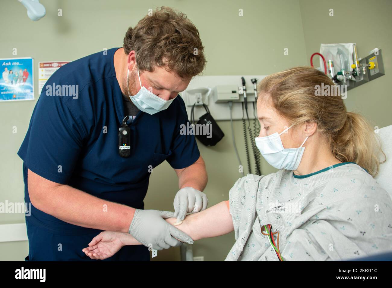 Kenneth Kallies, registered nurse, starts an IV on an emergency room ...