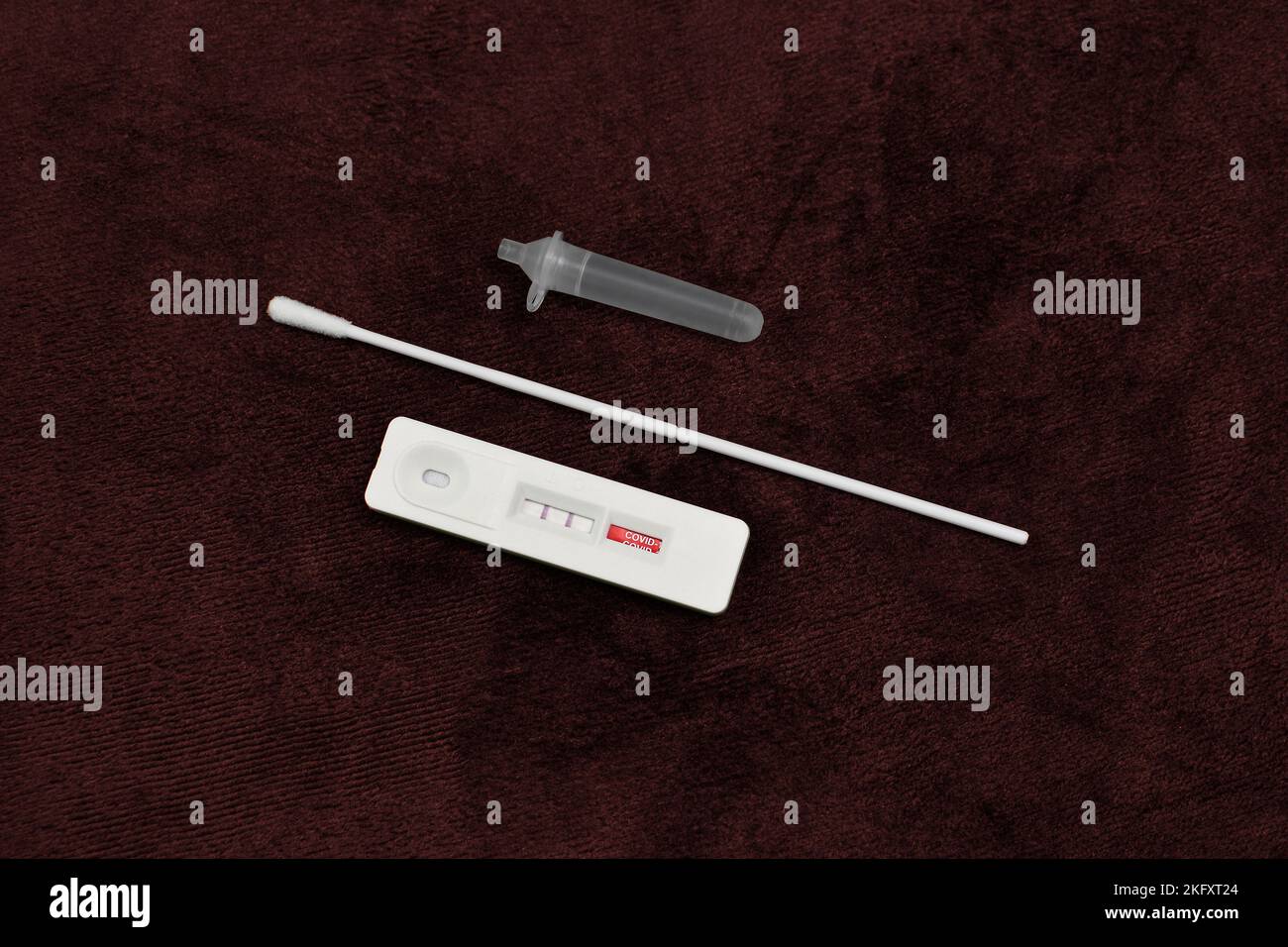 Antigen test kit (ATK) Covid-19 positive test result on dark red color ...