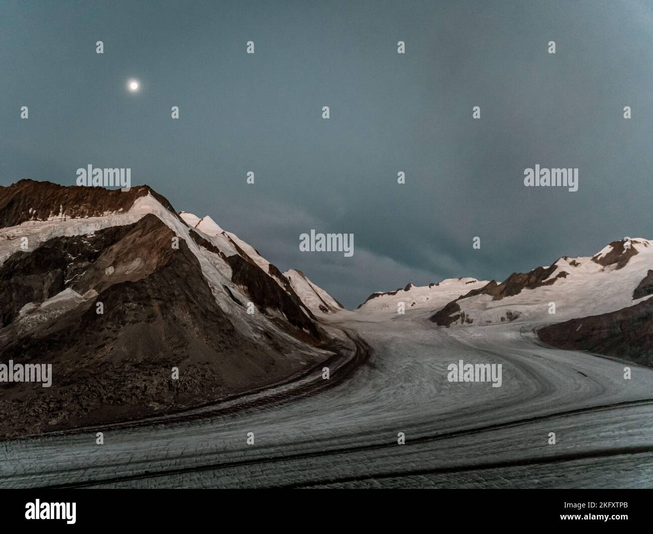 A beautiful shot of the snowy rocky mountains under an evening sky in ...