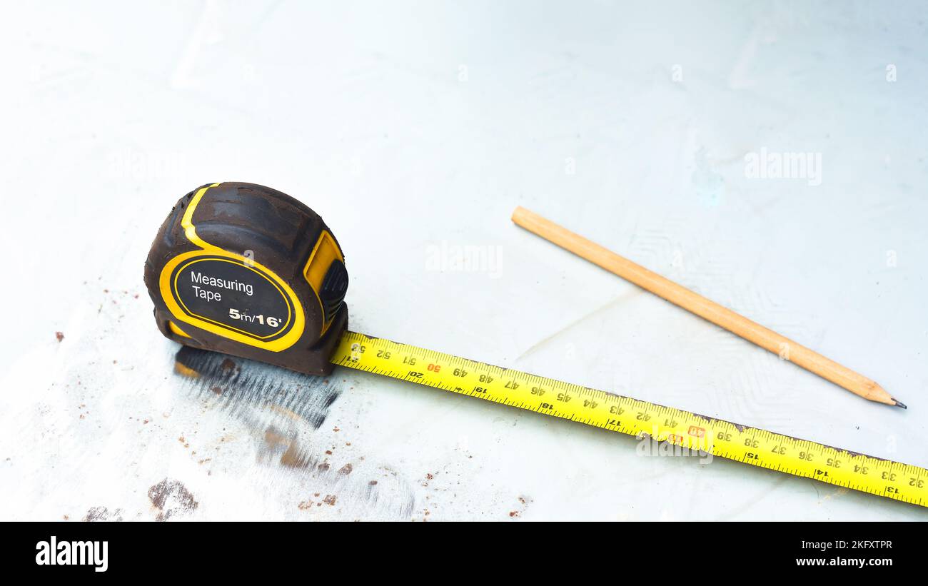 Measuring tape and pencil on metal sheet for handmade workshop Stock ...