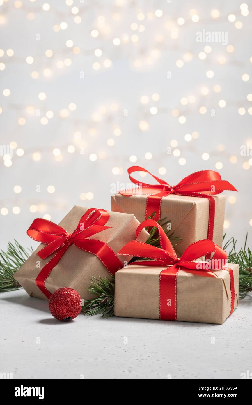 Christmas gift boxes. Craft paper and red ribbon Stock Photo - Alamy