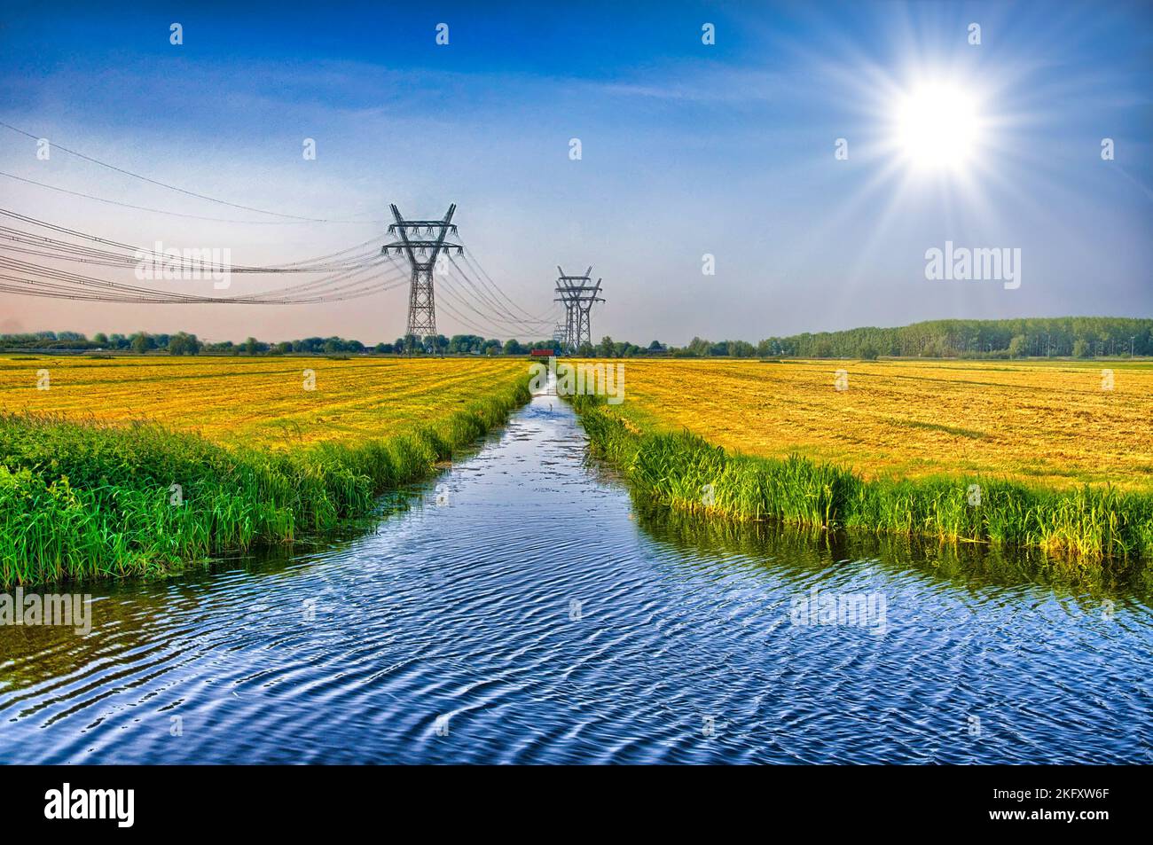 Dutch landscape with a canal and grass fields with mirror reflection in ...