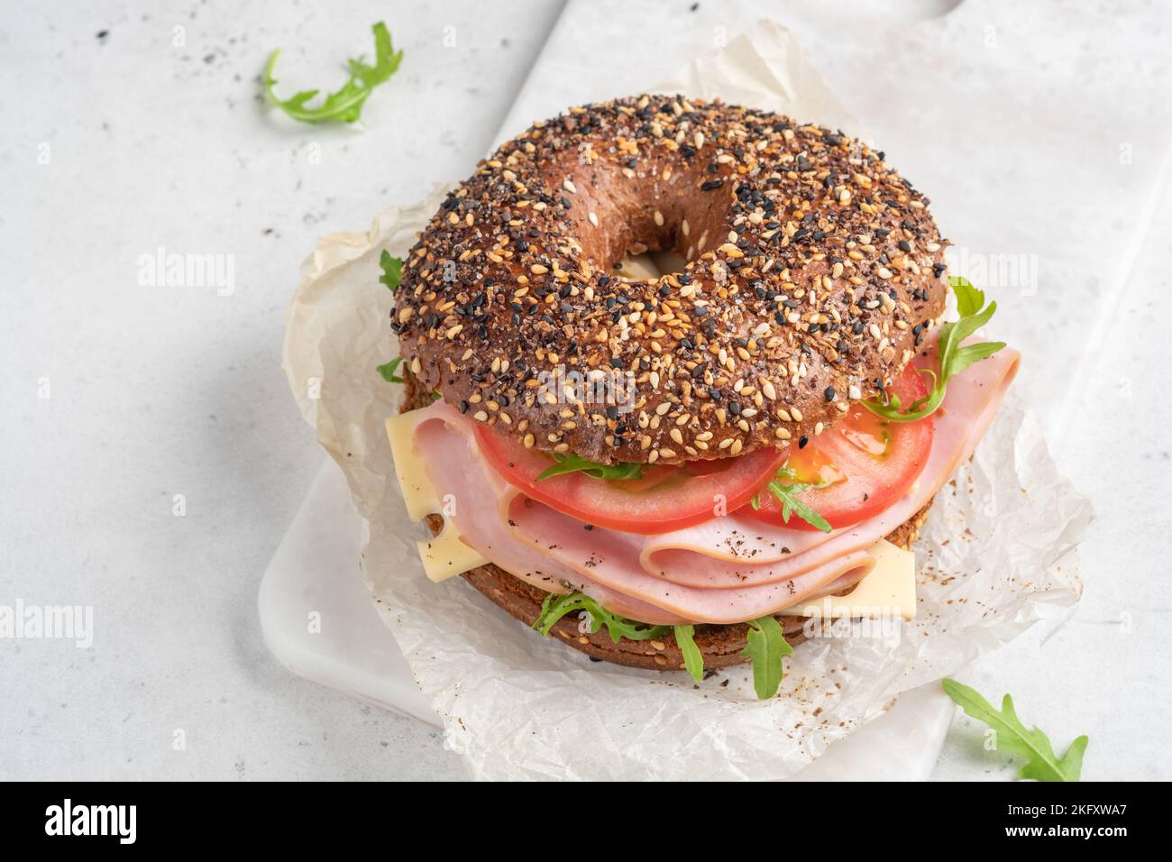 bagel filled with rocket, turkey ham, cream cheese and tomato Stock ...