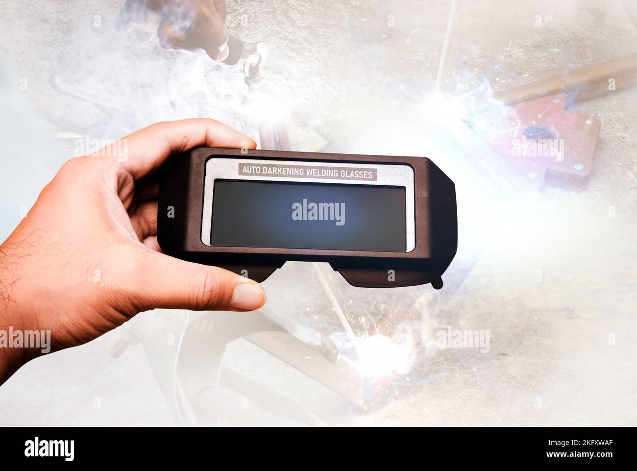 Auto darkening welding glasses in the mechanic hand with a welding on ...