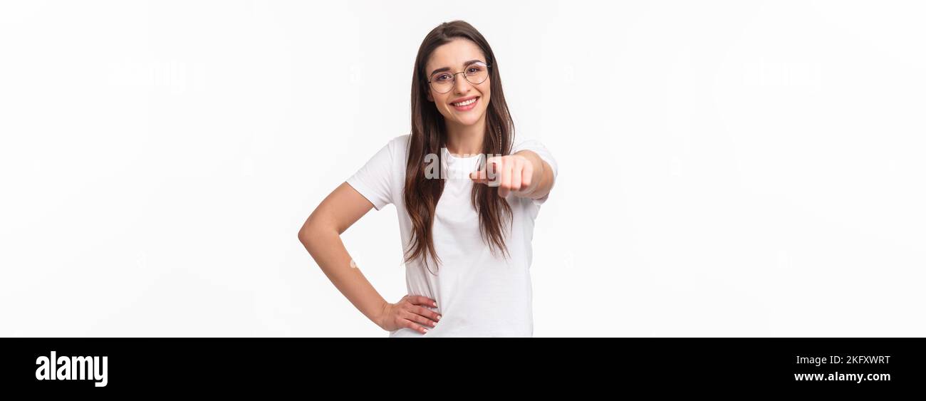 Waist-up portrait of happy smiling young woman inviting you join her ...