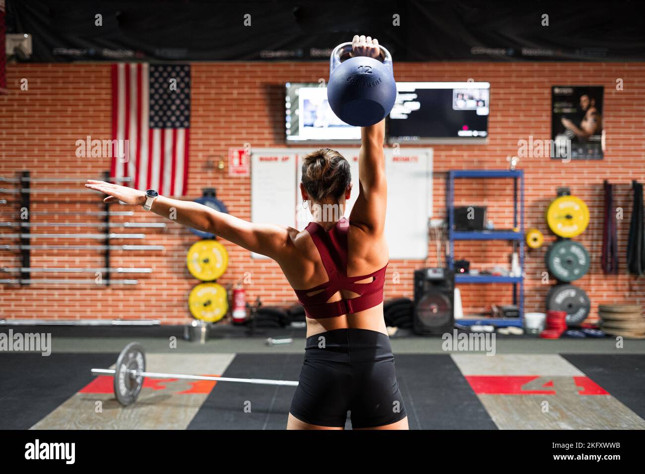 Caucasian girl standing on her back with her left hand outstretched and ...