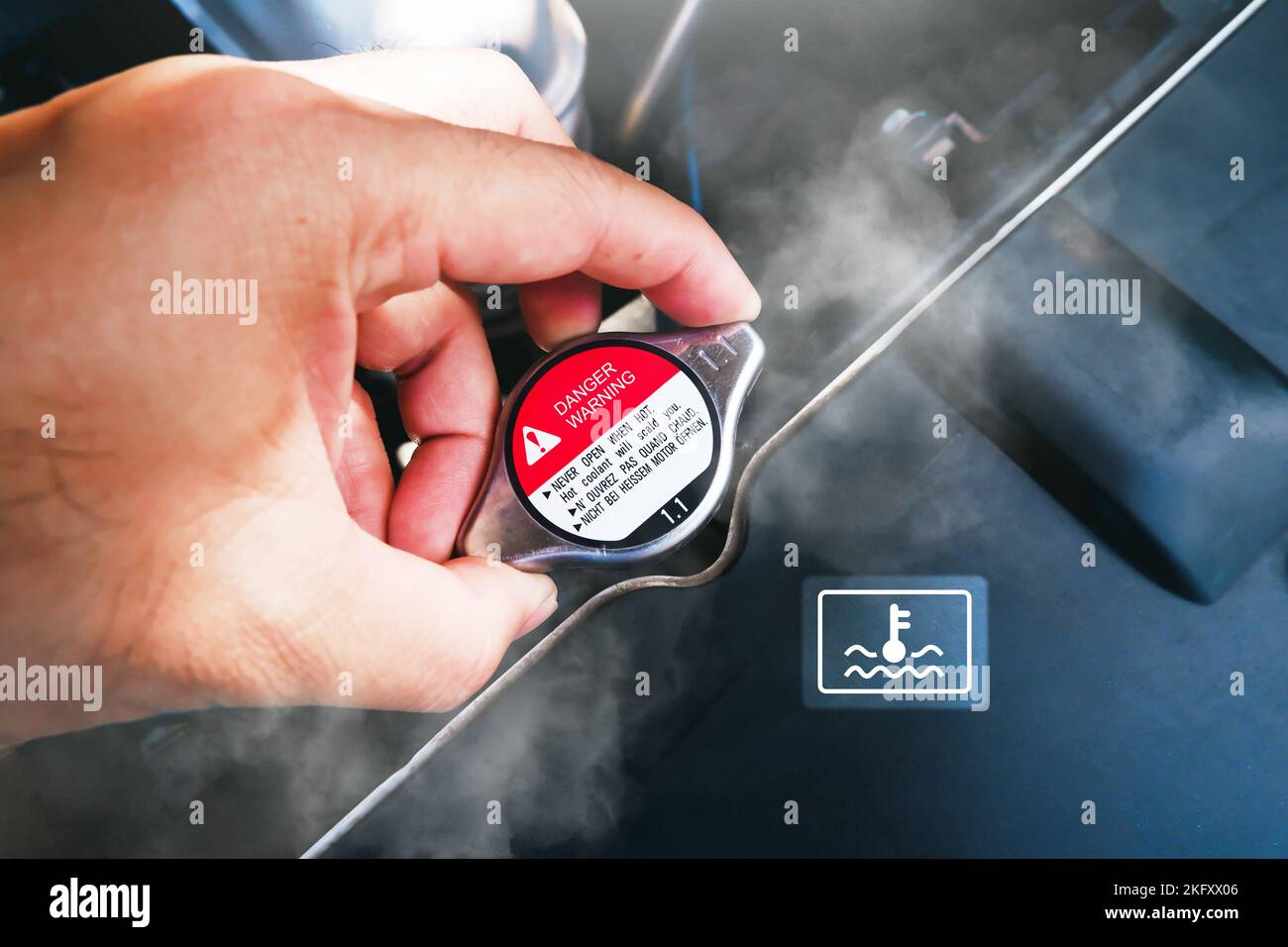 The mechanic hand was holding onto the car hot radiator cap with the ...