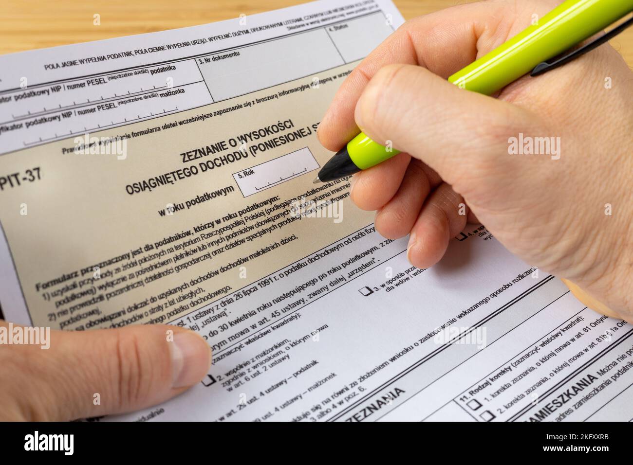 A man fills in an annual tax return to the tax office in Poland, Pit 37 ...