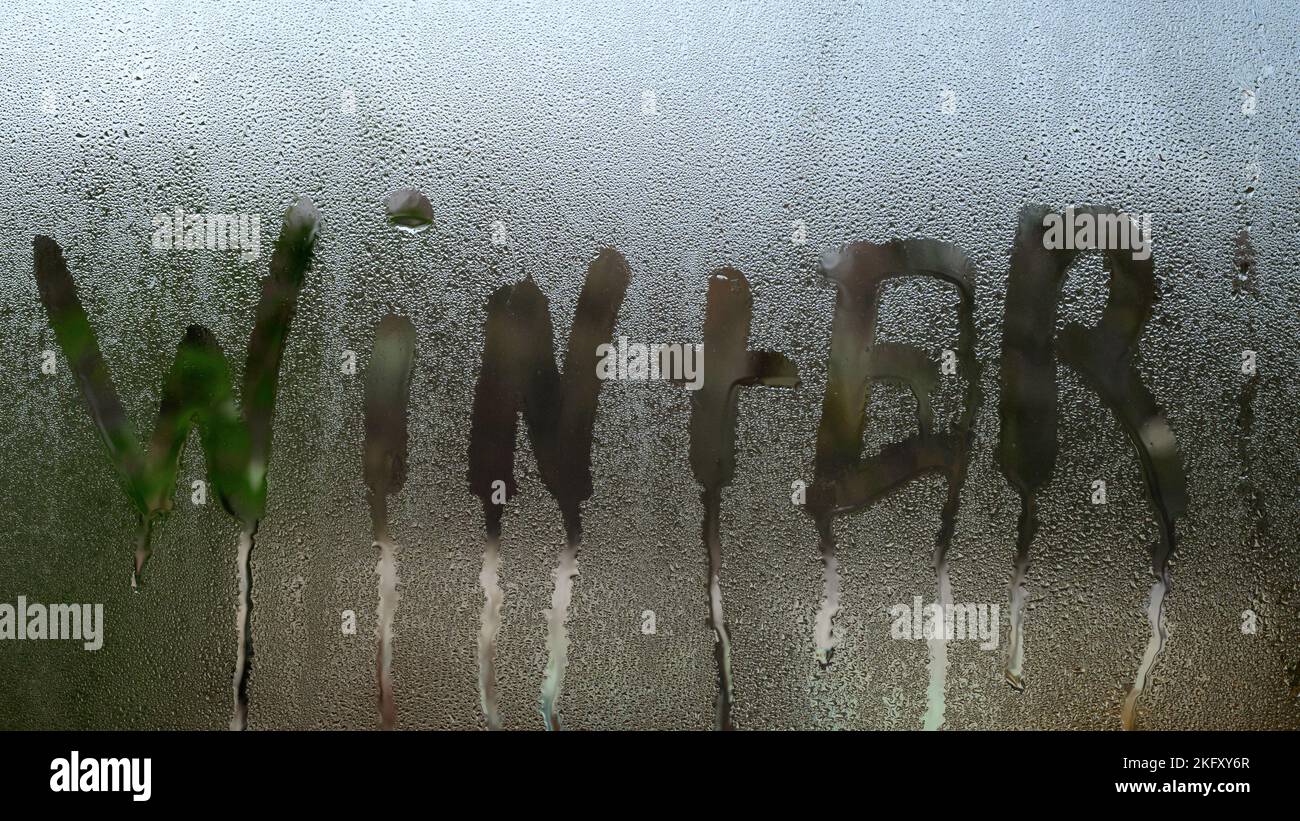 The inscription winter is painted on glass with condensation, the ...