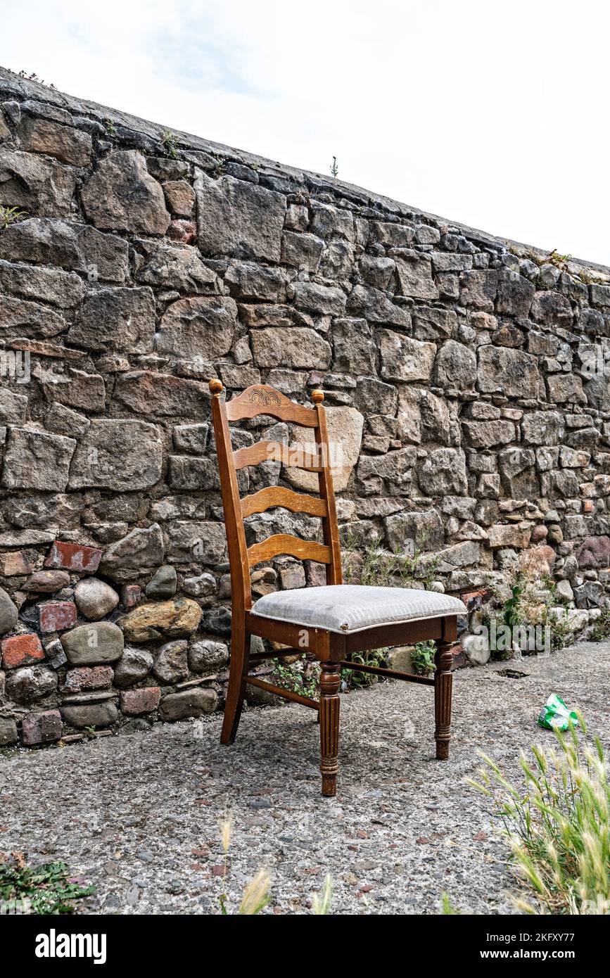 Wooden dining chair left in street Stock Photo - Alamy