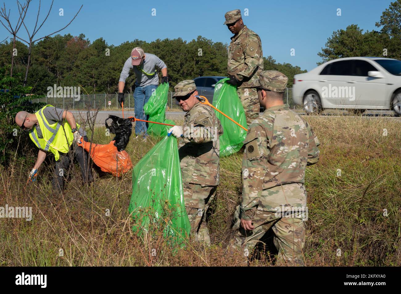 U.S. Army Central volunteers pick up trash during an organized cleanup ...