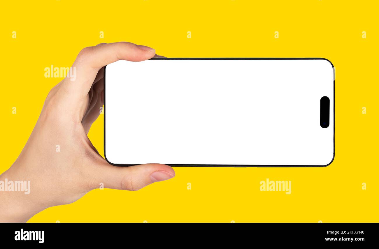 Phone screen mockup in hand with horizontal orientation for video. High ...