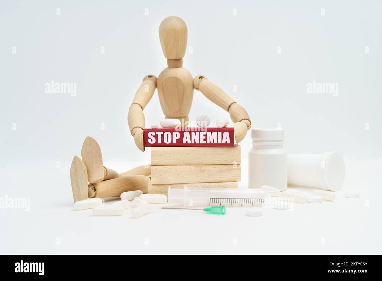 Medicine and healthcare concept. A figurine of a man sitting among ...