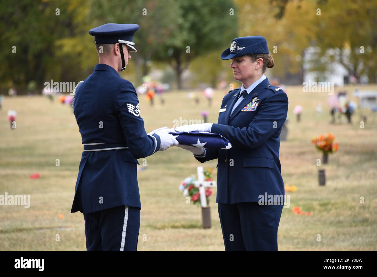 A 185th Air Refueling Wing Honor Guard member presents a U.S. flag to ...