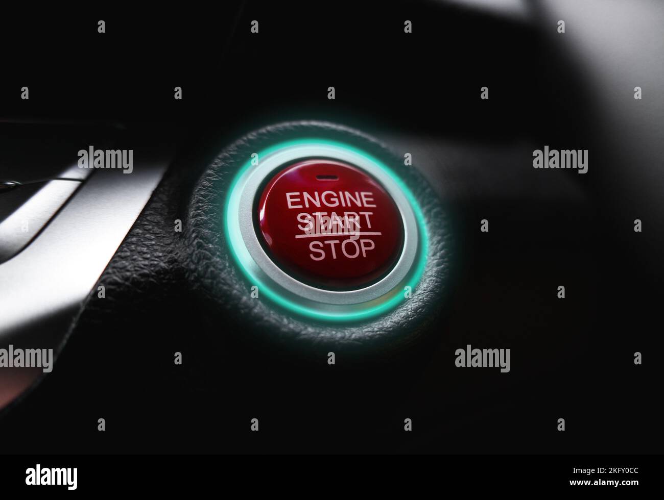 The electric car engine start stop button is illuminated by a green ...