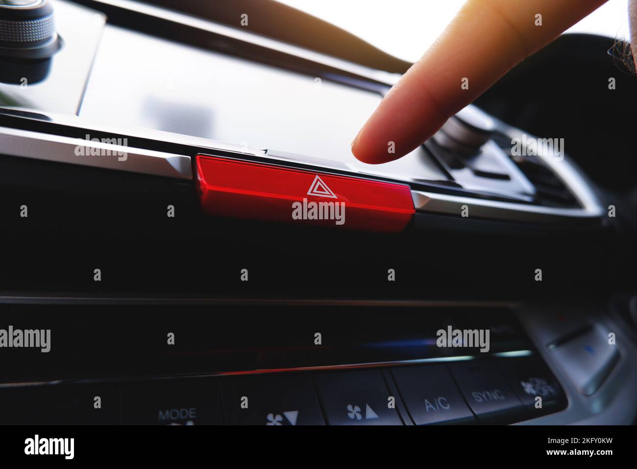 Pressing the emergency light button with the driver hand in the car ...
